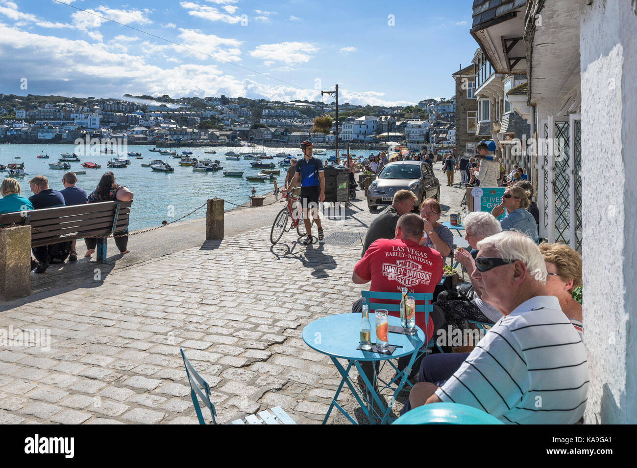 St Ives - holidaymakers relaxing on harbourside at St Ives Harbour in ...