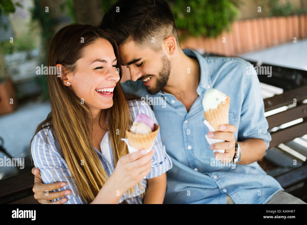 Happy couple having date and eating ice cream Stock Photo - Alamy