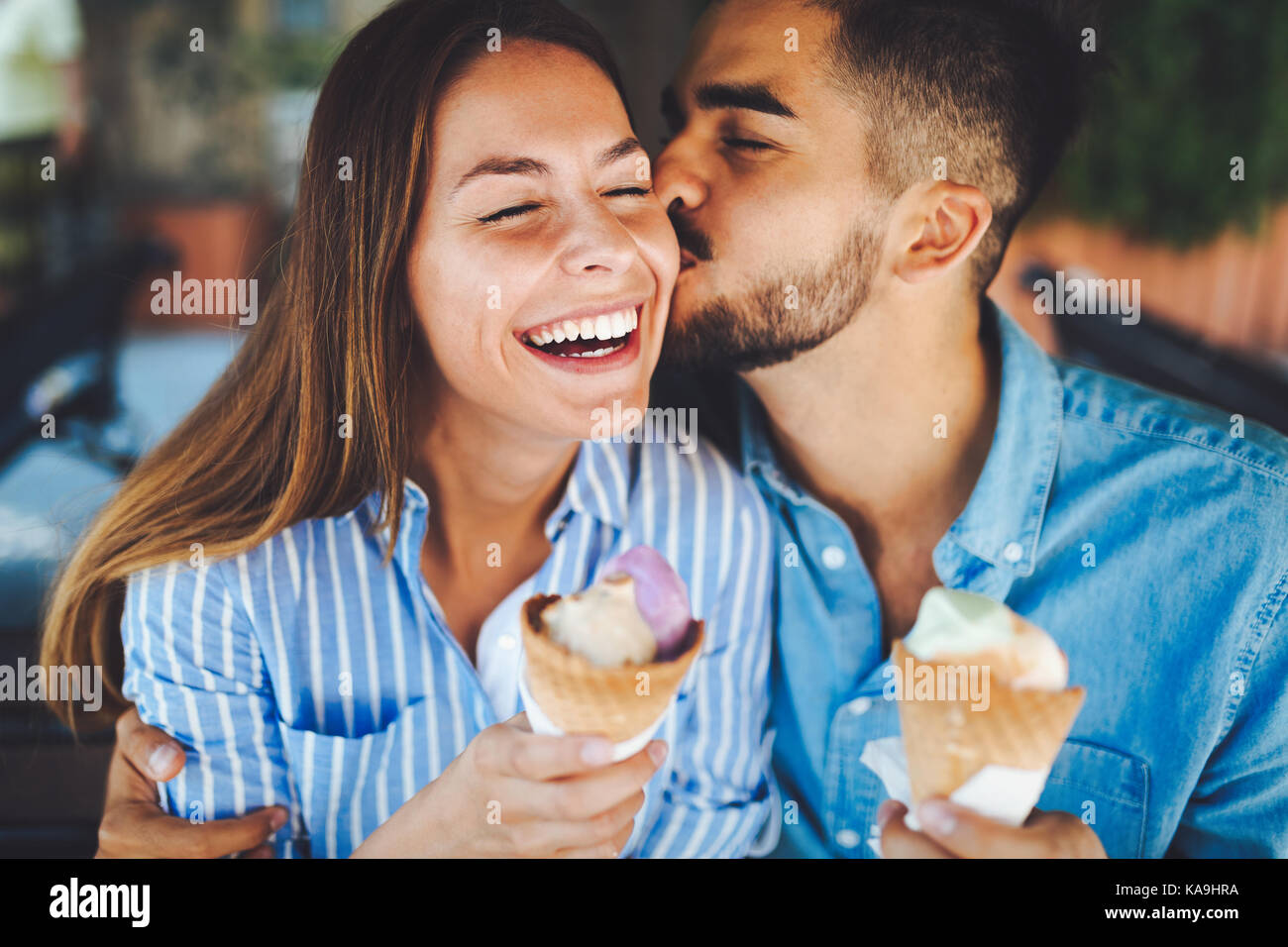 Happy couple having date and eating ice cream Stock Photo - Alamy