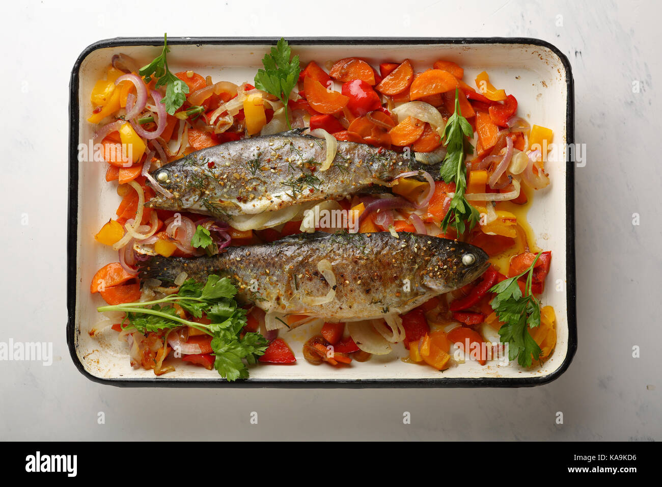 Baked river Fish with vegetables , food top view Stock Photo - Alamy