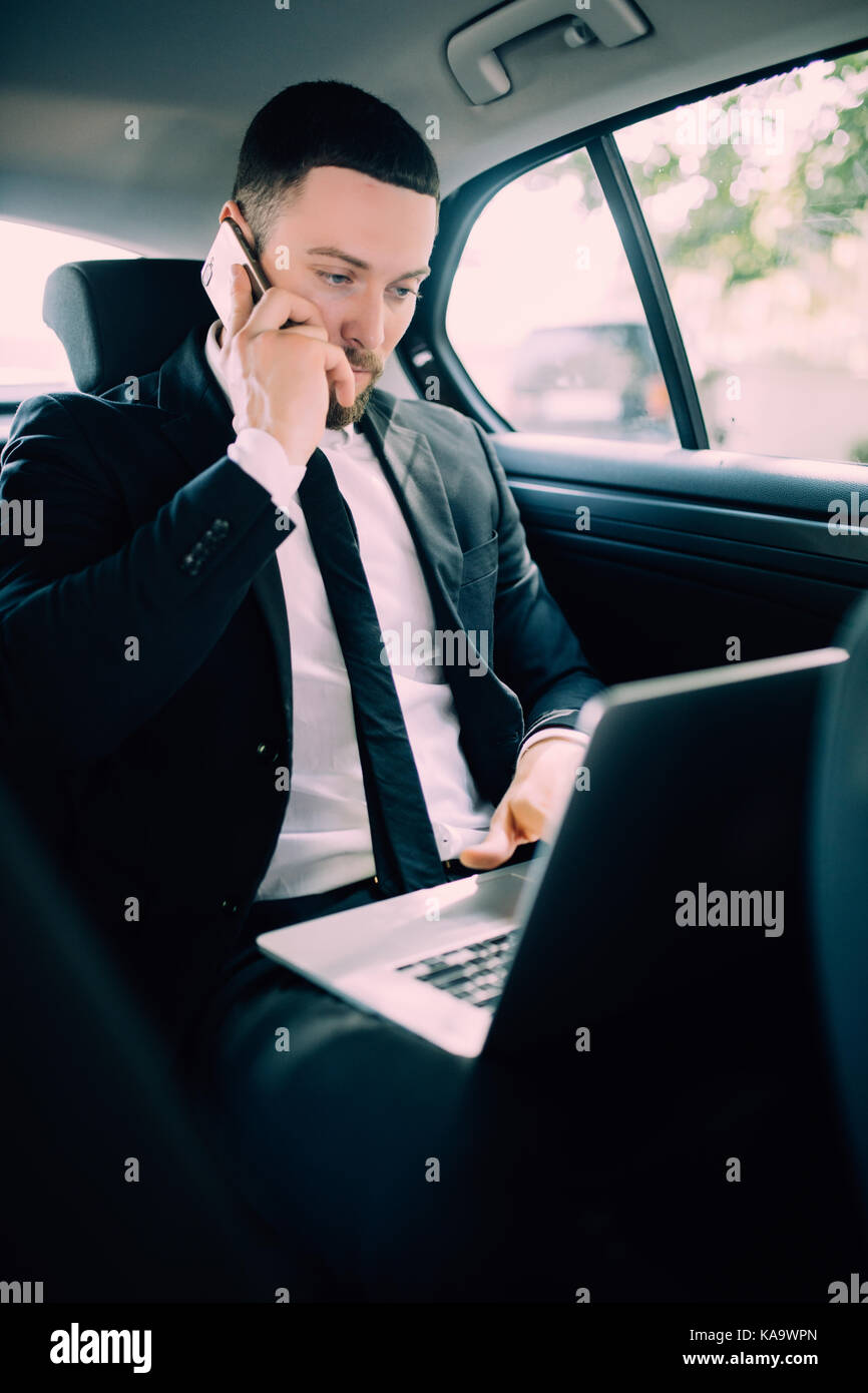 Handsome businessman glasses driving talking hi-res stock photography ...