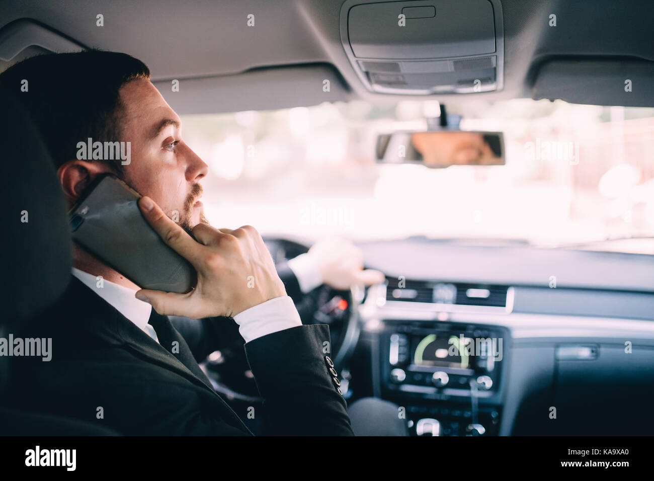 man using phone while driving the car Stock Photo - Alamy