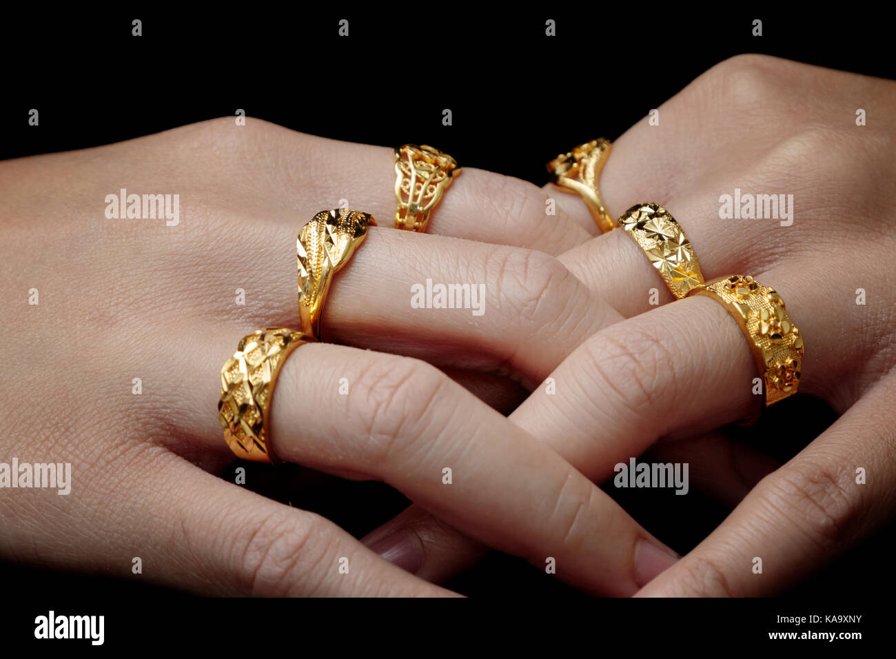 woman's hand with many jewelry rings on black background Stock Photo ...
