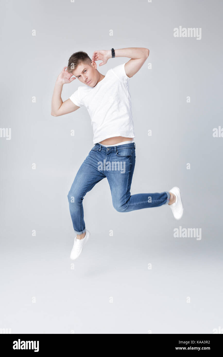 handsome man in jeans and jacket jumping Stock Photo - Alamy