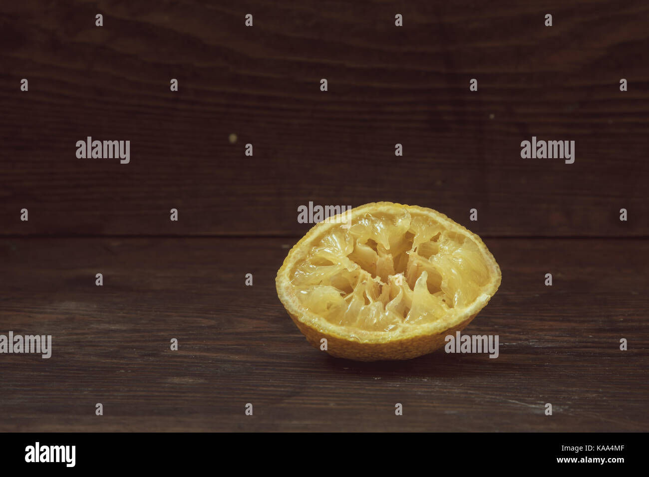 Used lemon on wood background. Vintage look Stock Photo - Alamy