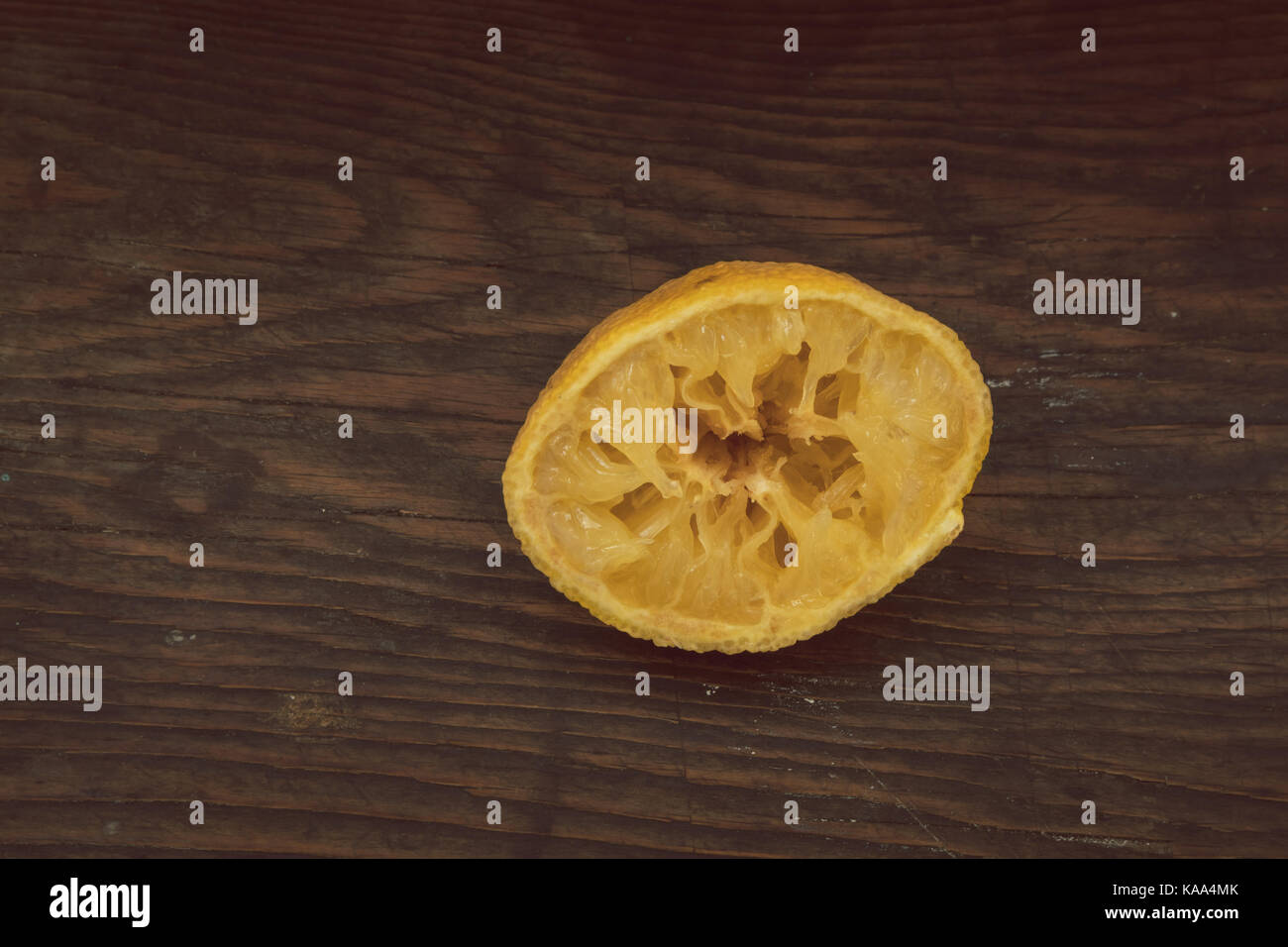 Used lemon on wood background. Vintage look Stock Photo - Alamy