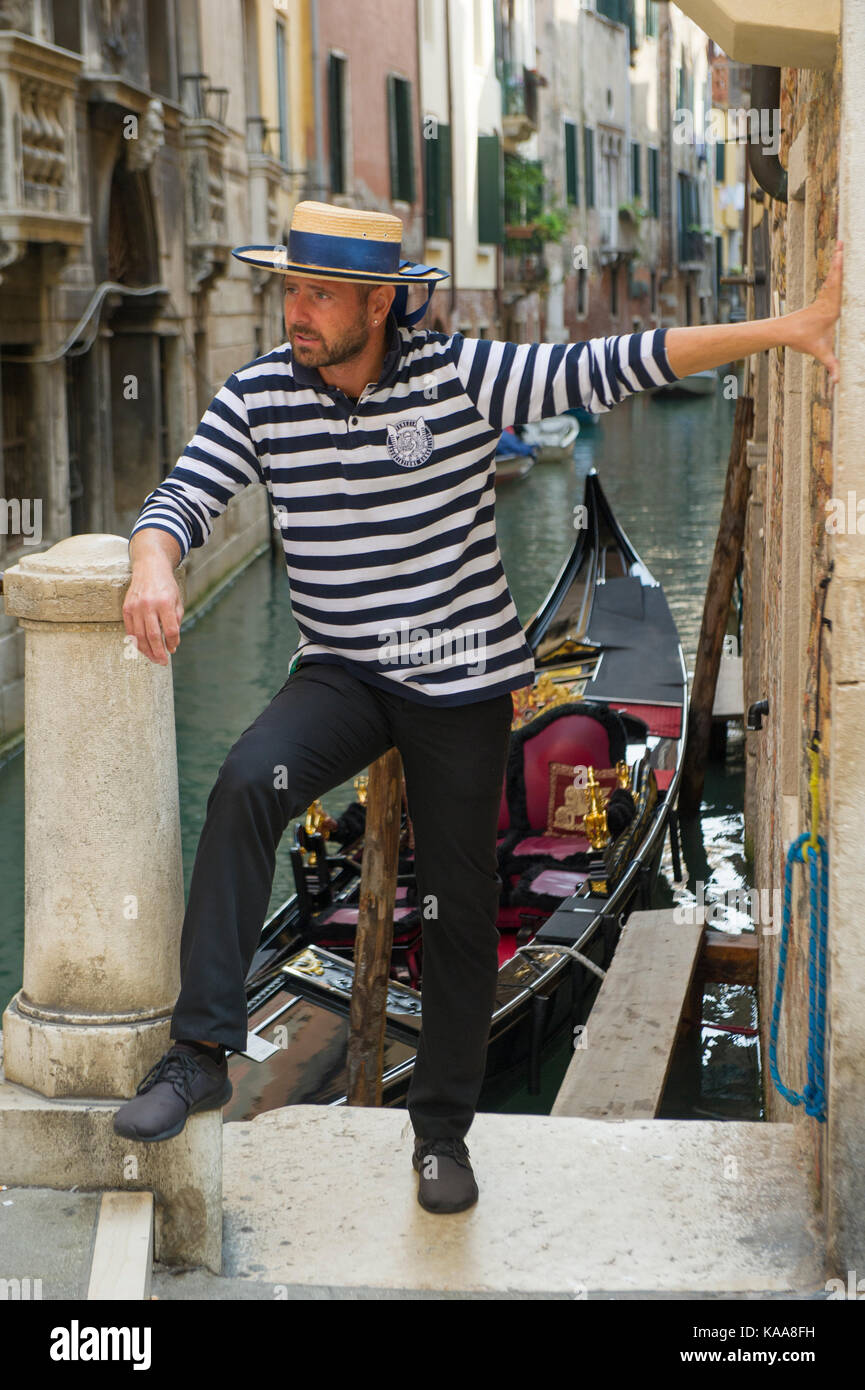 A gondolier by his gondola in Venice Stock Photo - Alamy