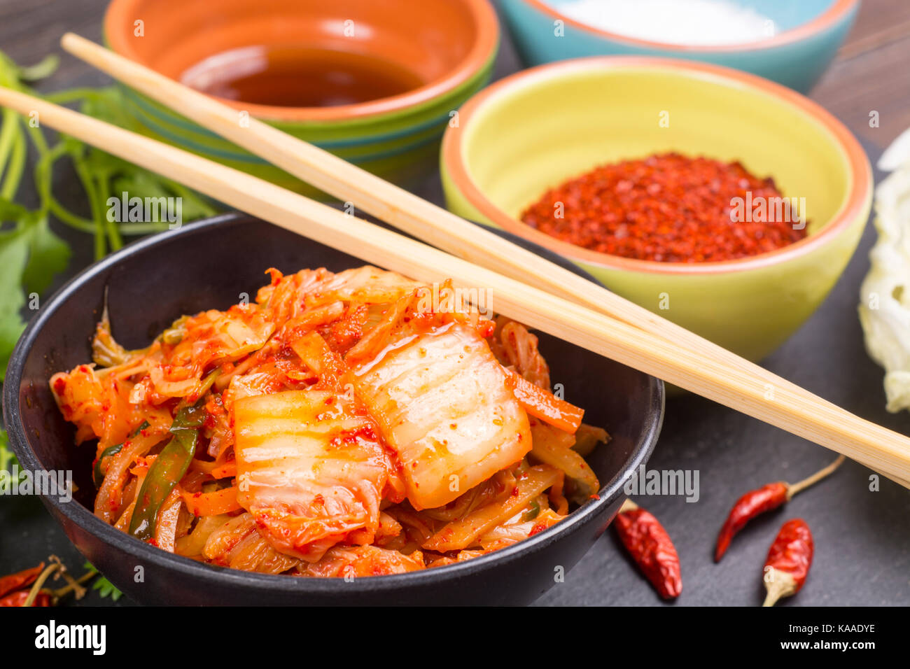 Kim chi korean pickled napa cabbage on black plate Stock Photo - Alamy