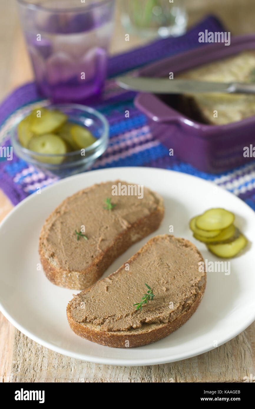 Homemade liver pate with bread and canned cucumber. Rustic style ...
