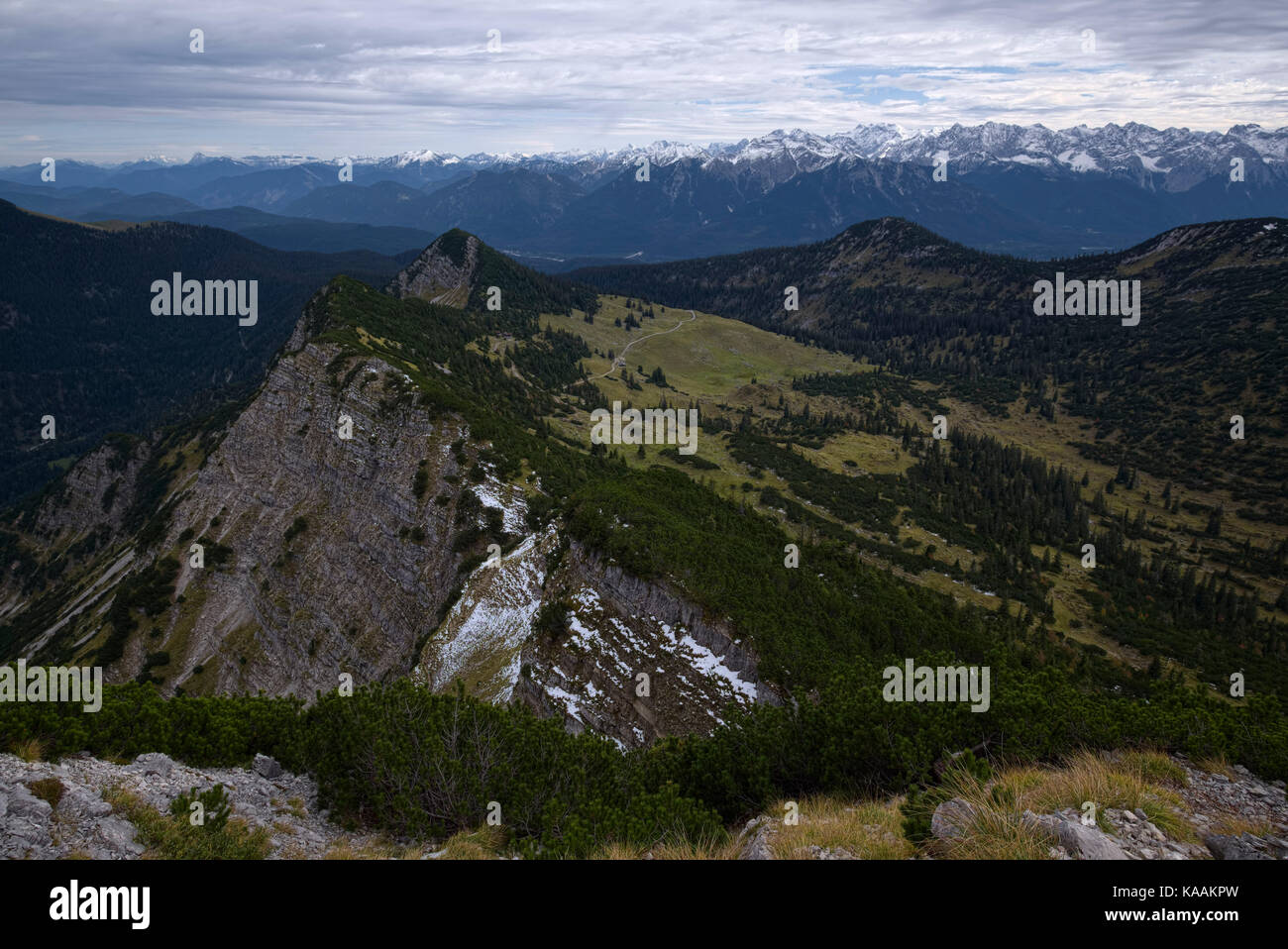 view of steep rock walls and snowy mountain panorama from summit of ...