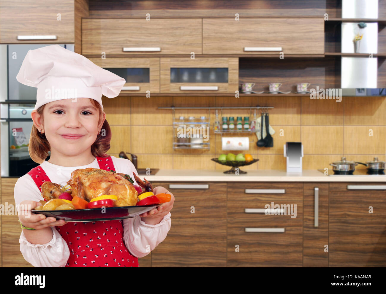 little girl cook with chicken in kitchen Stock Photo - Alamy