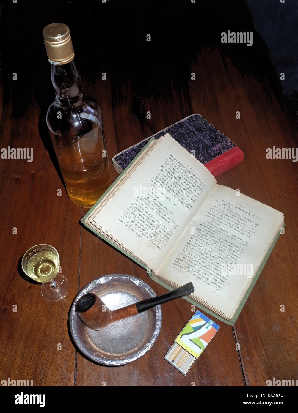 Smoking with book and liqueur glass Stock Photo - Alamy