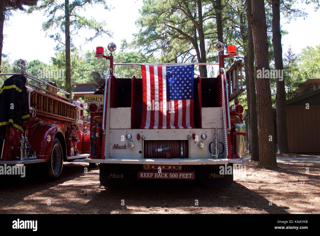An American flag is proudly displayed on the rear of a vintage Mack ...