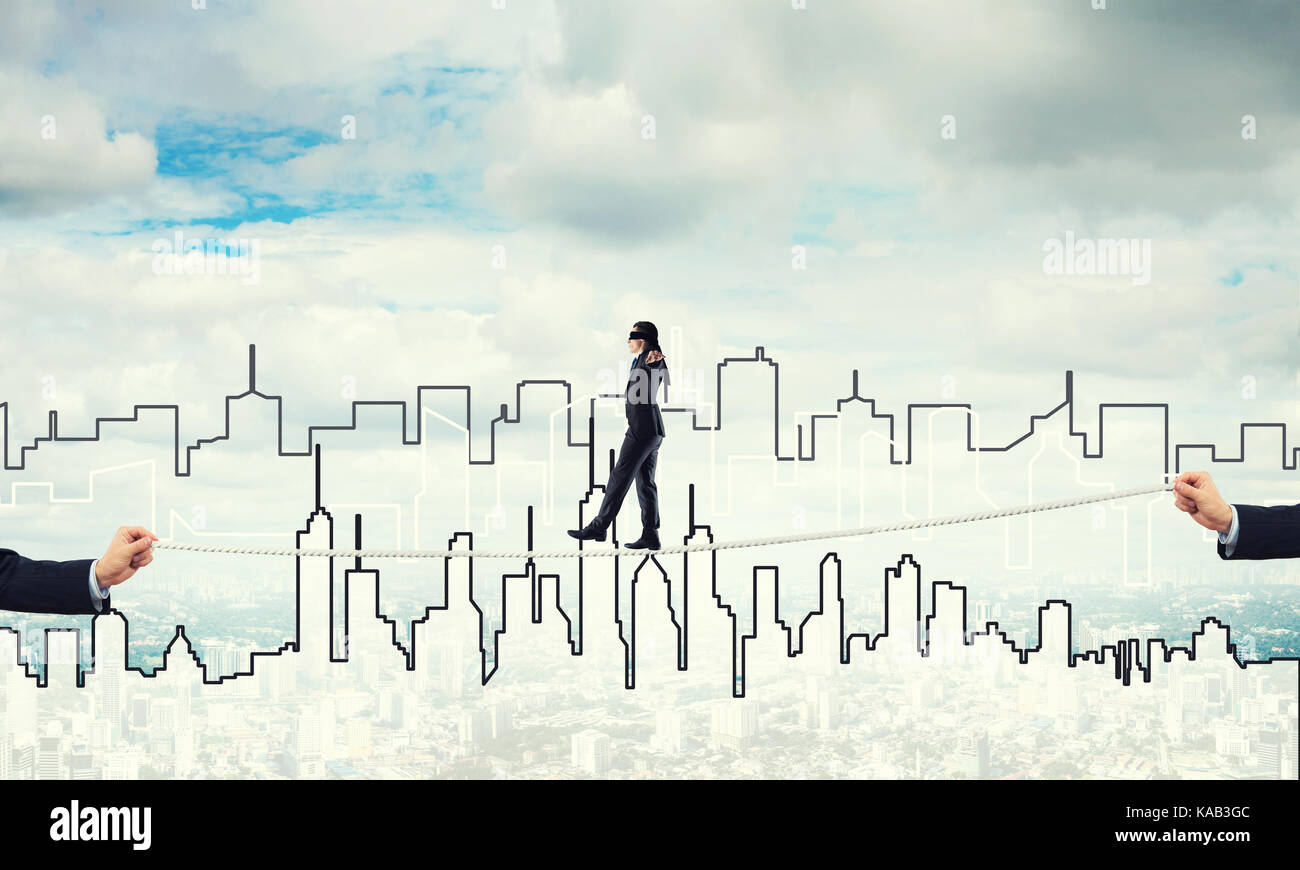 Business concept of risk support and assistance with man balancing on ...