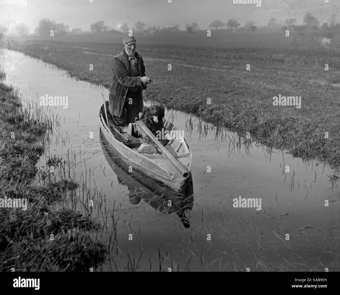 Snowden Slights poling punt and dog with him YORYM S25 Stock Photo - Alamy