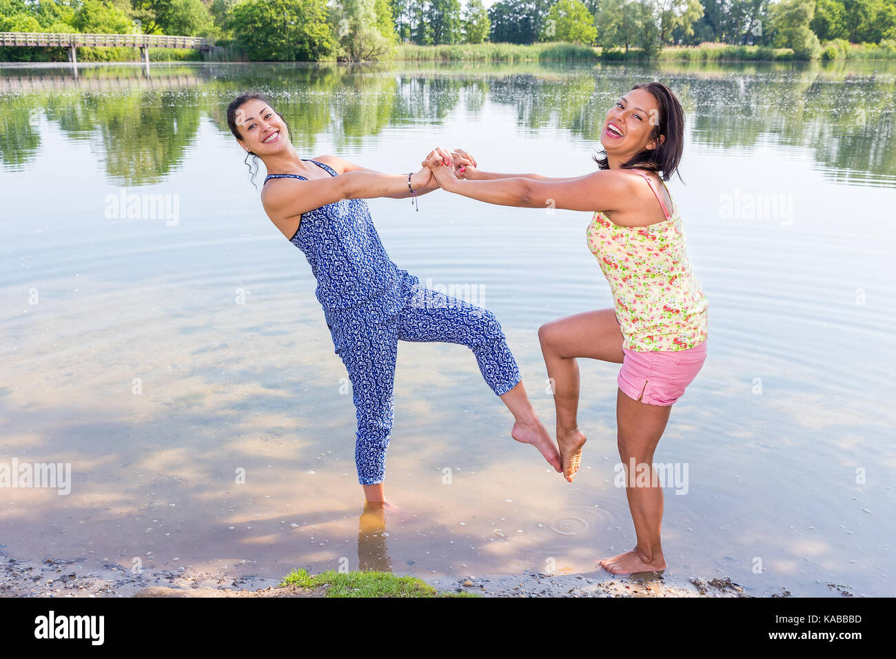 Two friends playing together in natural water Stock Photo - Alamy