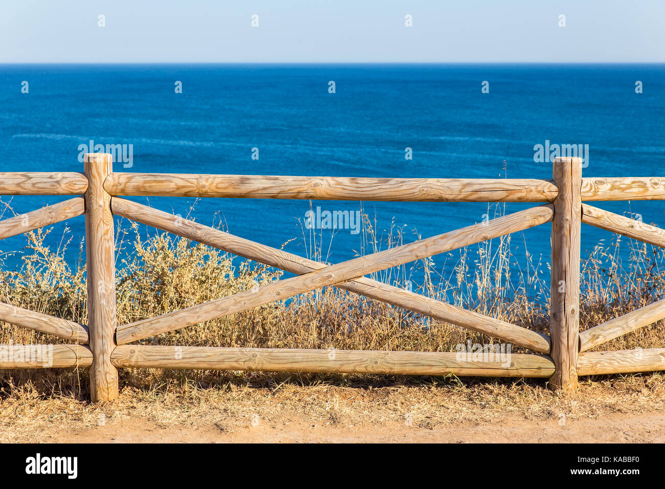 Wooden fence at shore with blue sea and horizon Stock Photo - Alamy
