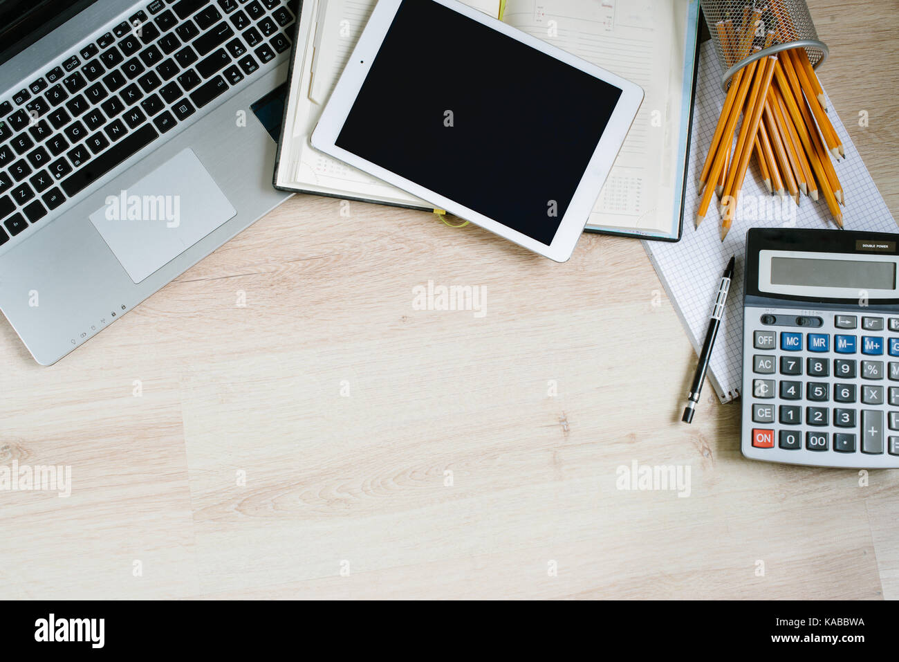 Work office desk table with laptop, tablet, supplies and calculator ...
