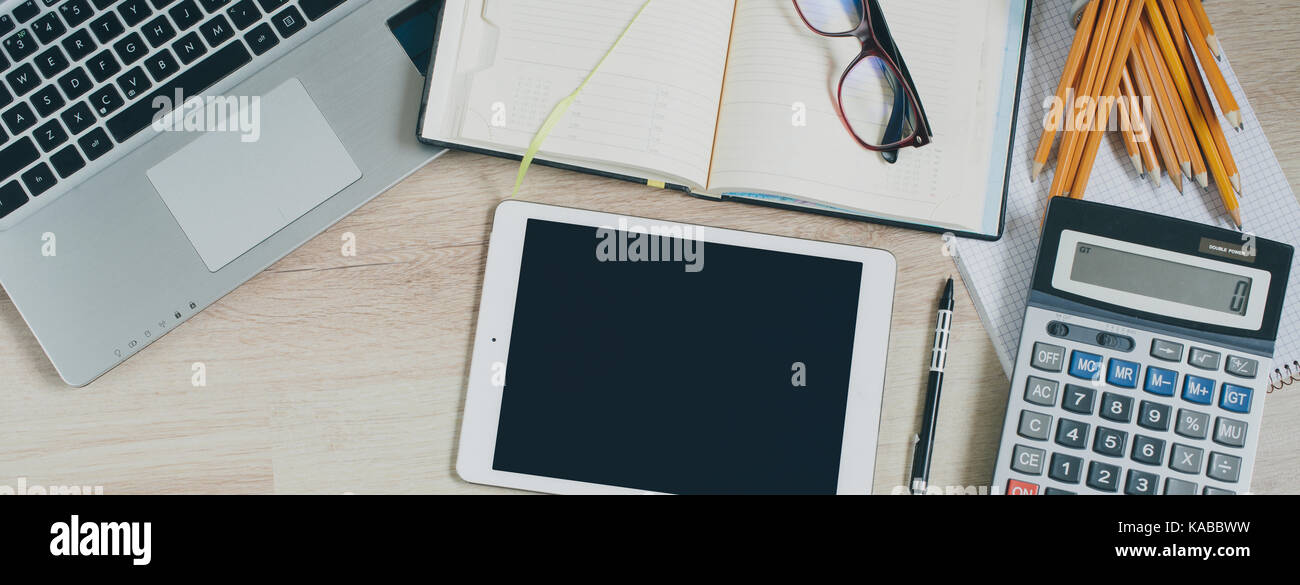 Office desk table with computer, tablet, supplies and calculator. Top ...