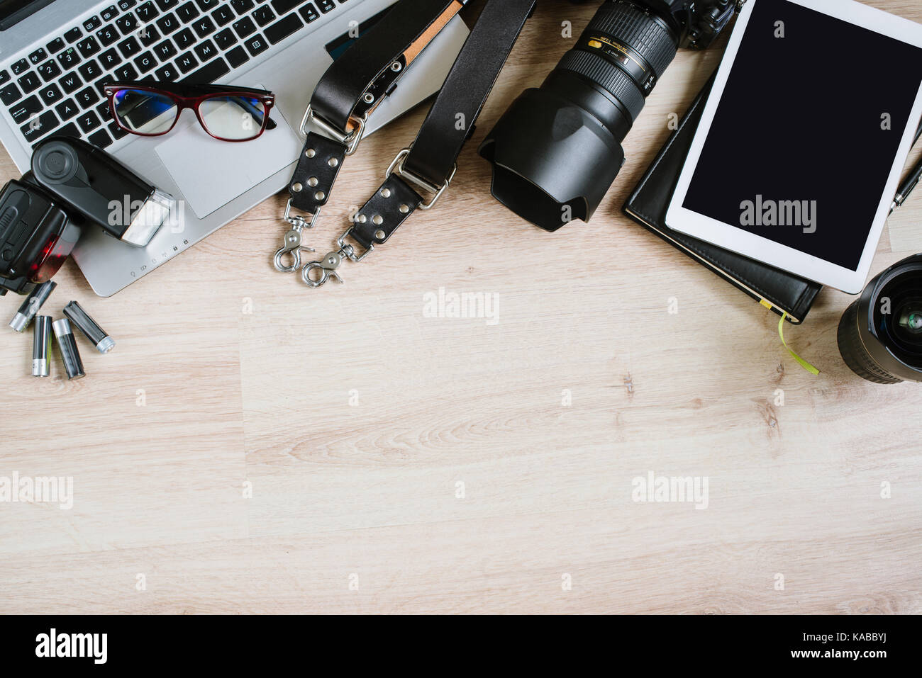 Photography hipster work table set with computer, tablet, film, lenses ...