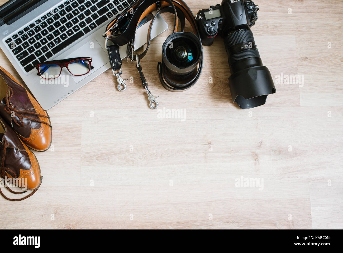 Photography hipster work table set with computer, tablet, film, lenses ...