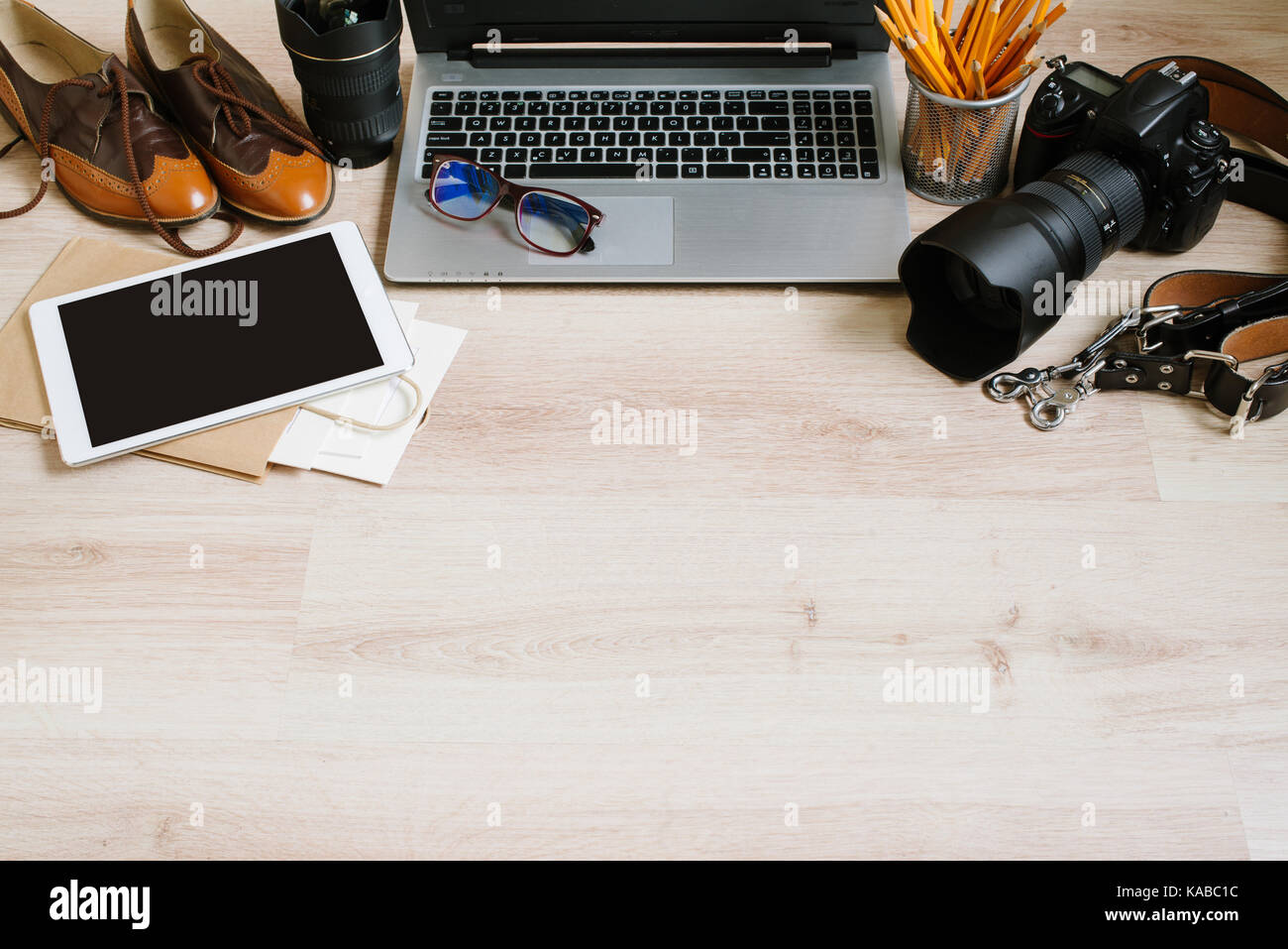 Photography hipster work table set with computer, tablet, film, lenses ...