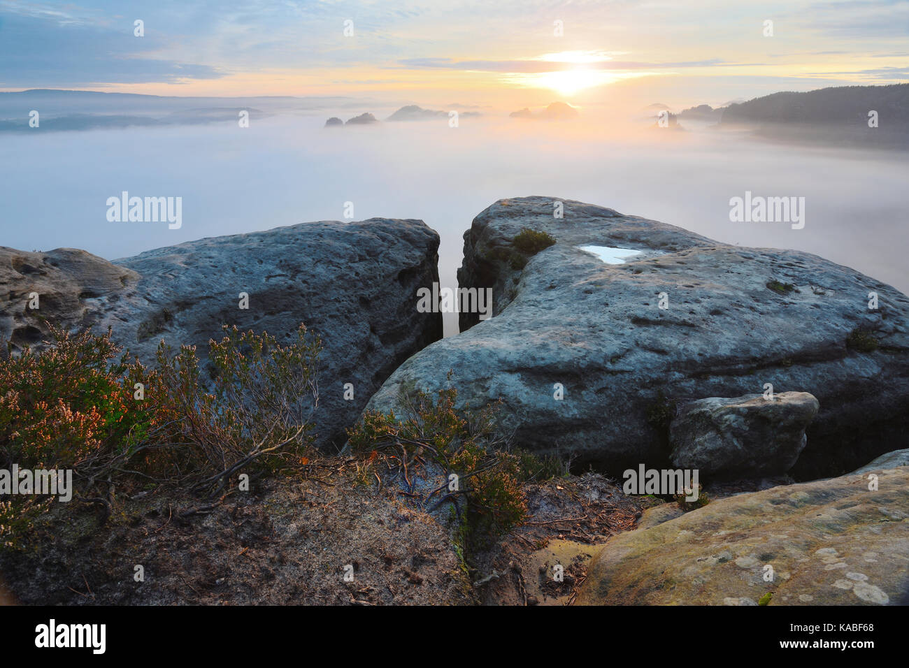 Strong sun rays make long strips in the mist. Autumn sunny view over ...