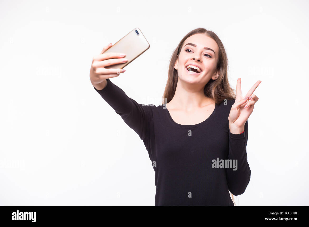 Gorgeous young woman in street style clothes taking selfie with mobile ...