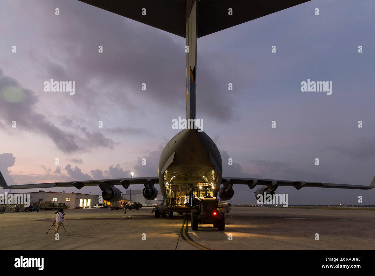 Members from 502nd Logistics Readiness Squadron load supplies onto a C ...