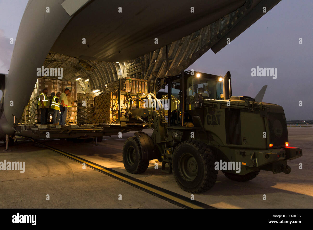 Members from 502nd Logistics Readiness Squadron load supplies onto a C ...