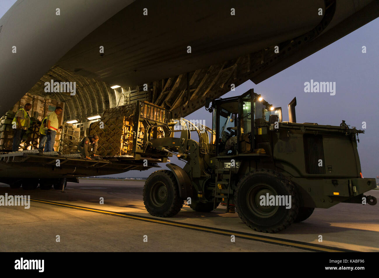 Members from 502nd Logistics Readiness Squadron load supplies onto a C ...