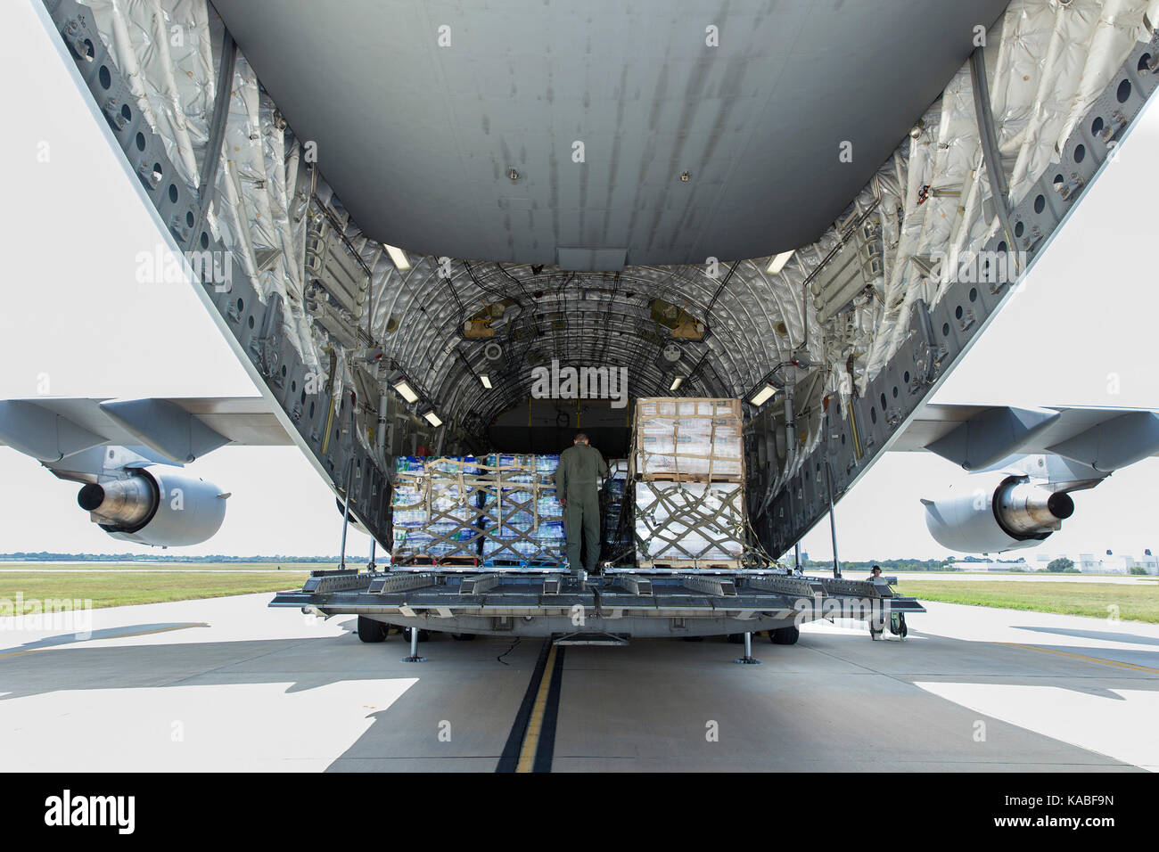 Members from 502nd Logistics Readiness Squadron load supplies onto a C ...