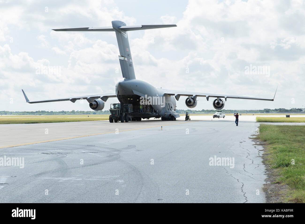 Members from 502nd Logistics Readiness Squadron load supplies onto a C ...