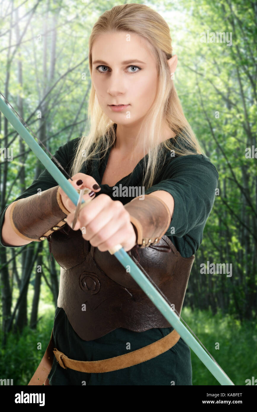 female wood elf using bow and arrow Stock Photo - Alamy