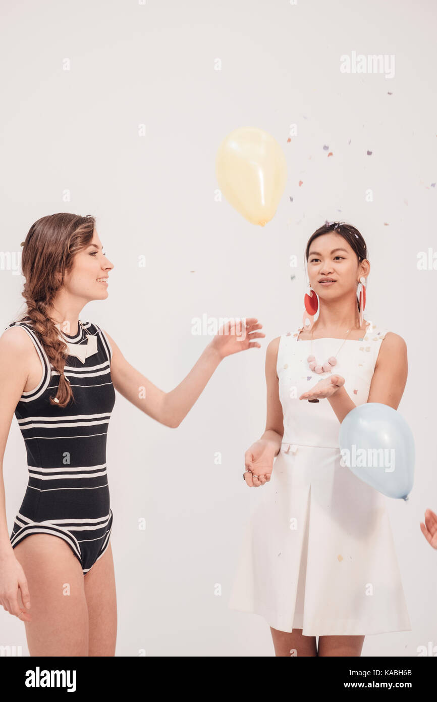 Girls having fun with balloons and confetti Stock Photo - Alamy