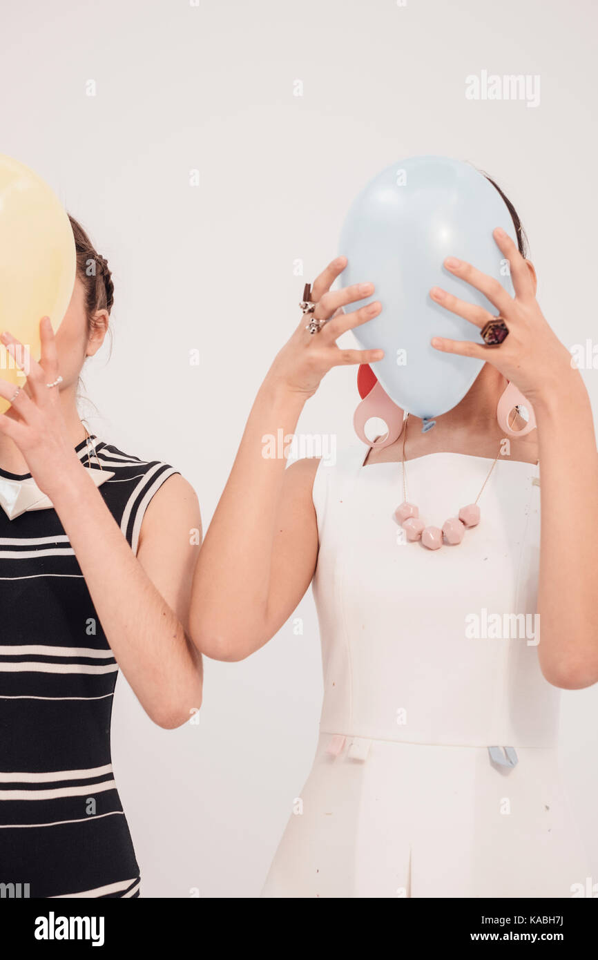 Girls having fun with balloons and confetti Stock Photo - Alamy