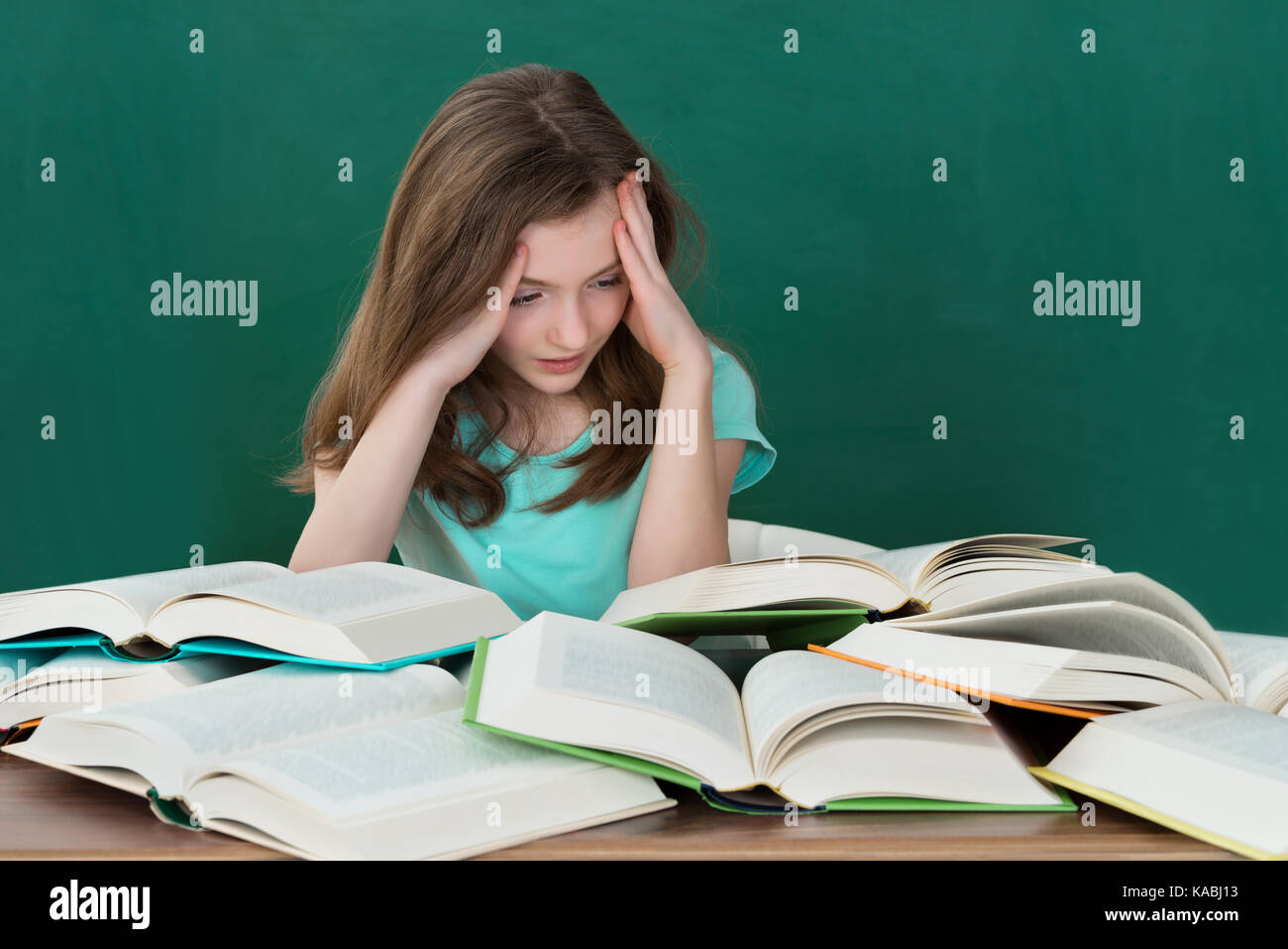 Sad girl sitting in classroom hi-res stock photography and images - Alamy