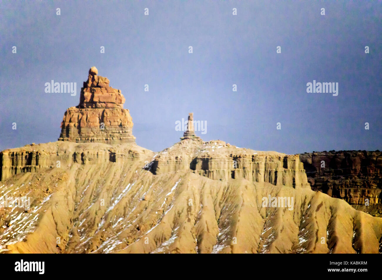 A vertical stone formation inset in a valley on a blue sky Stock Photo ...