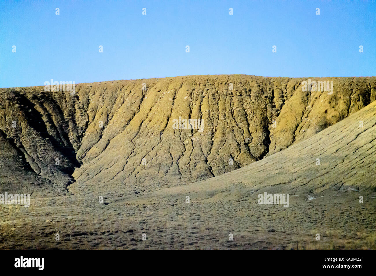 A sloping hill on a bright blue sky Stock Photo - Alamy