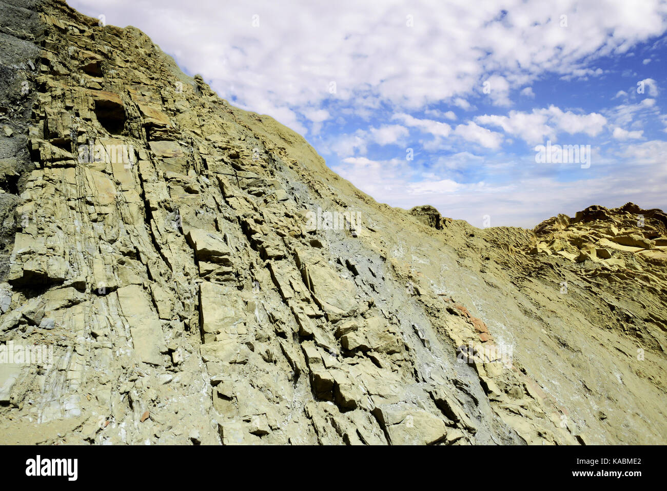 Looking up a rock side cliff set on a bright blue sky Stock Photo - Alamy