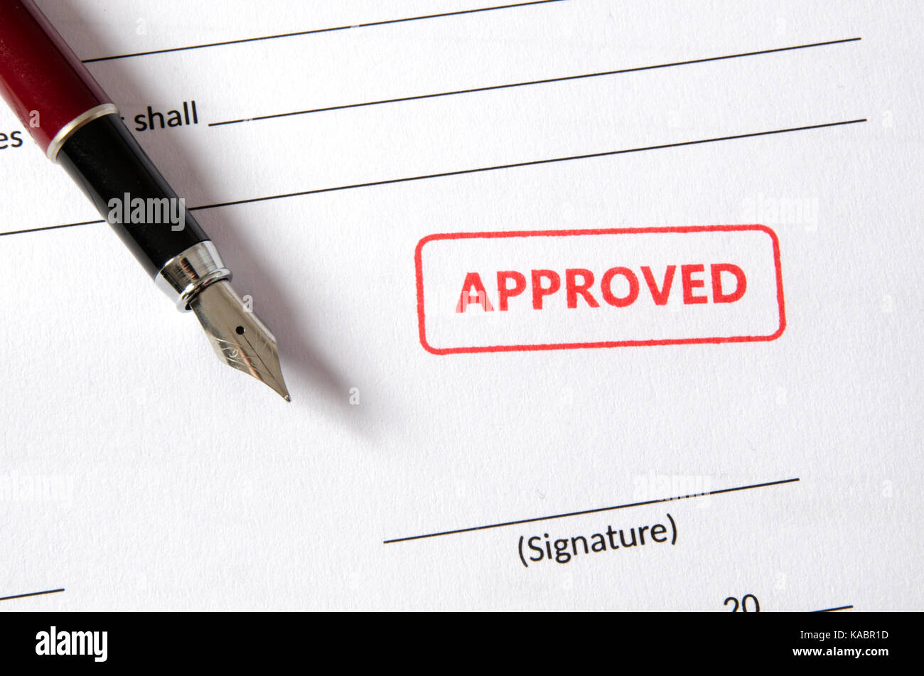 Approved stamp on document. Empty signature field, fountain pen. stamp ...