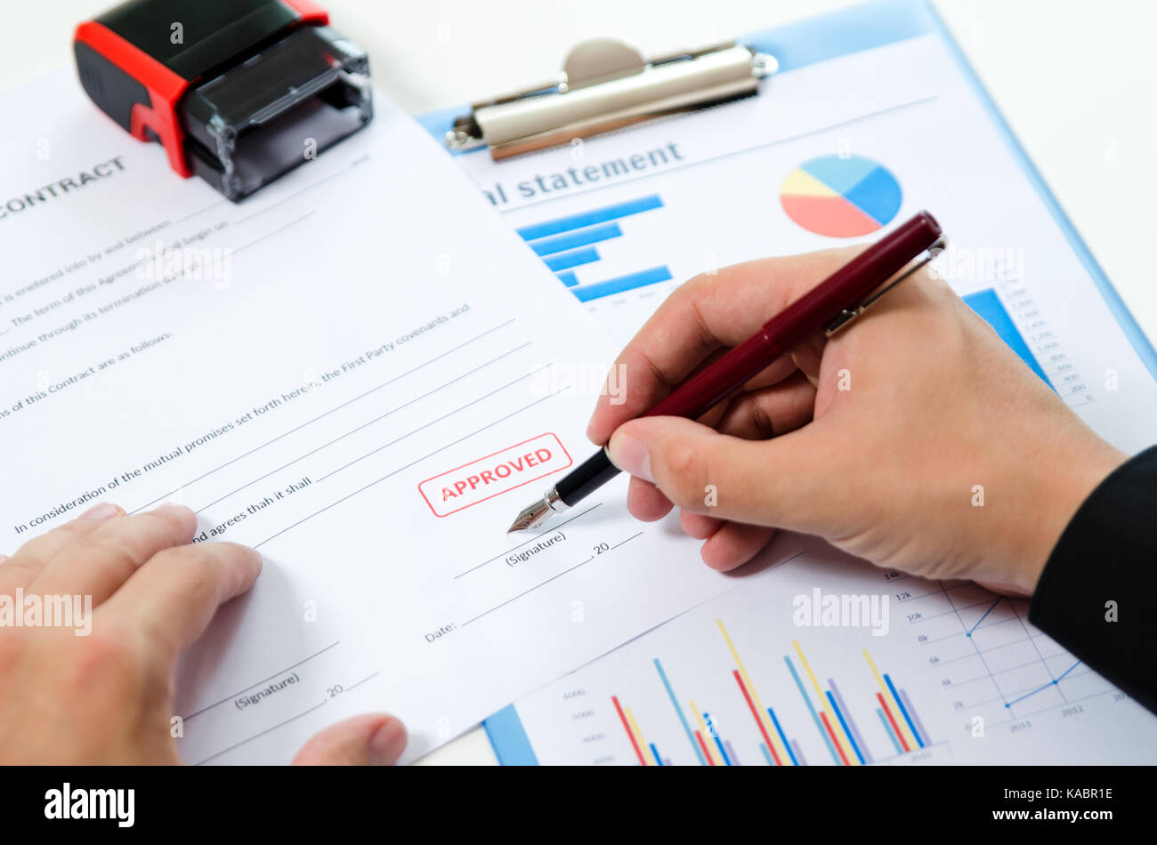 Man signs the contract with pen. Approved stamp on document. stamp ...