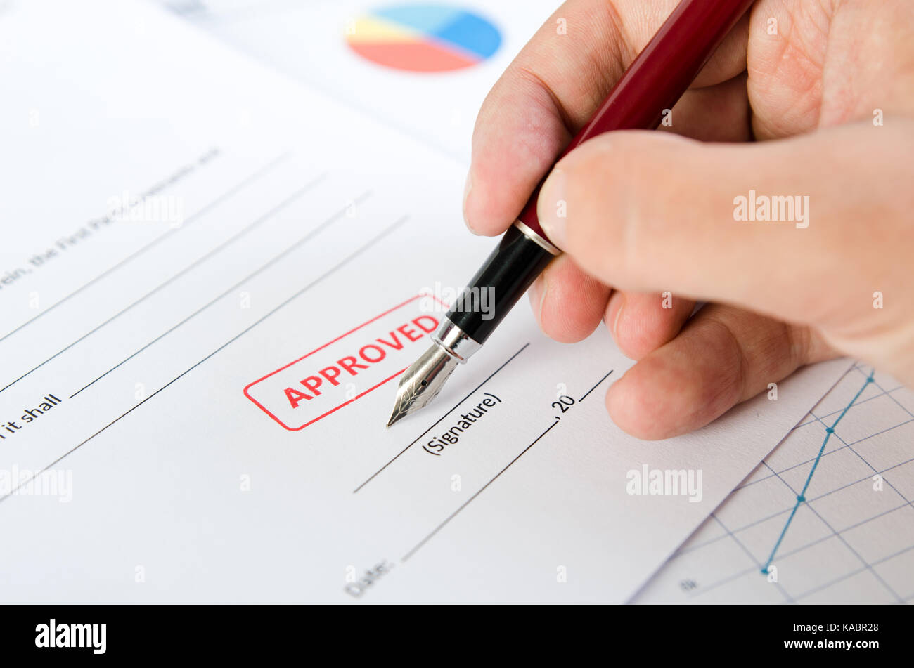 Man signs the contract with pen. Approved stamp on document. stamp ...
