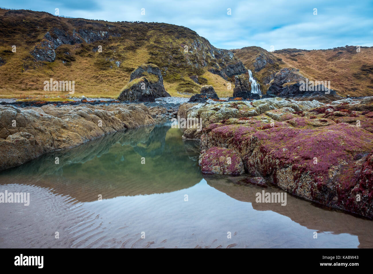 A pool and waterfall on St Cyrus beach Stock Photo - Alamy