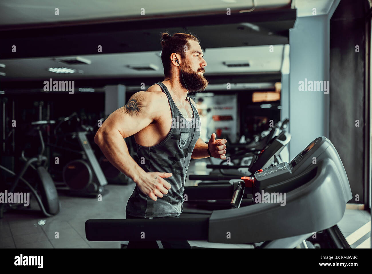 Muscle man running on treadmill Stock Photo - Alamy