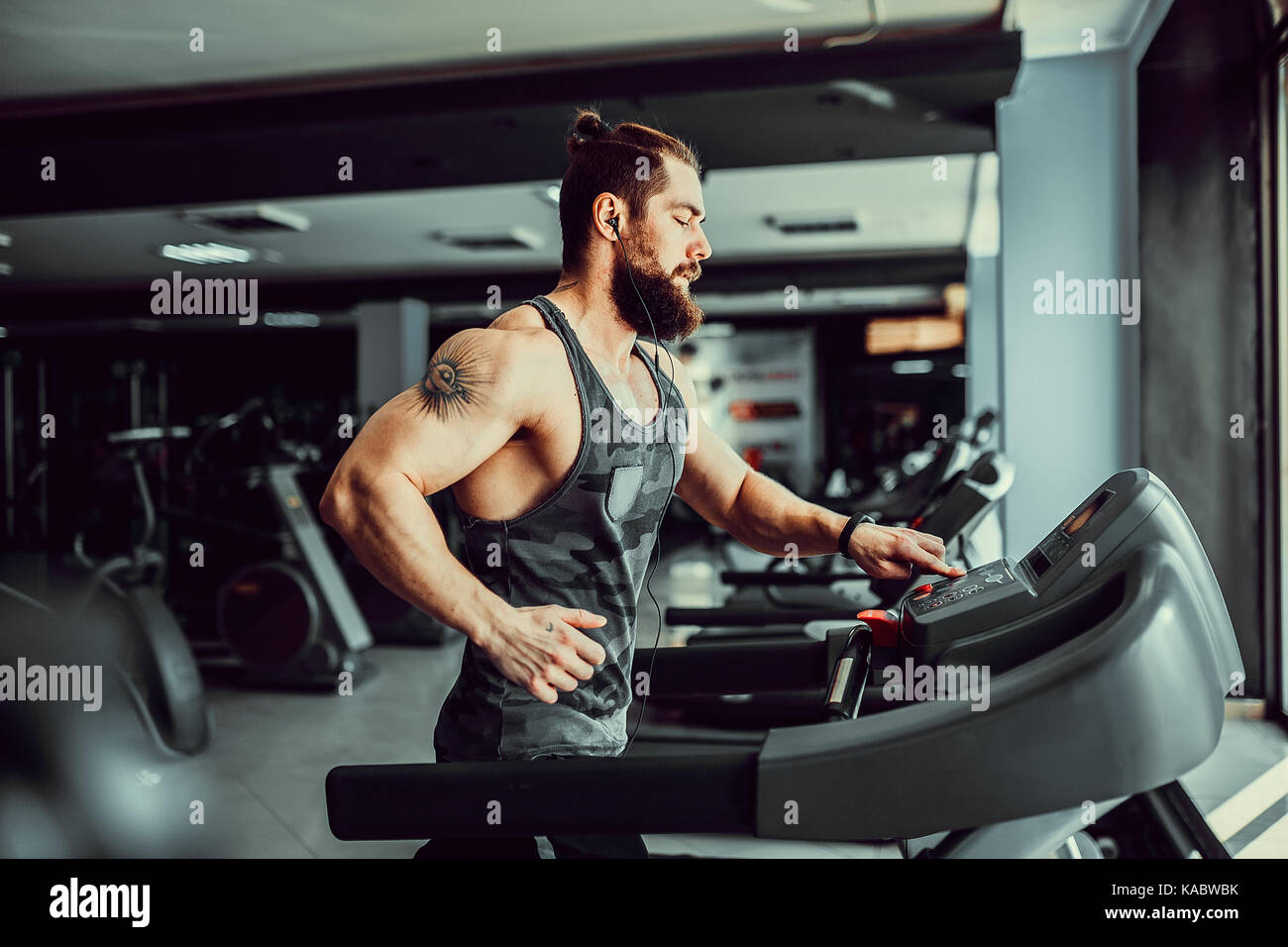 Muscle man running on treadmill Stock Photo - Alamy