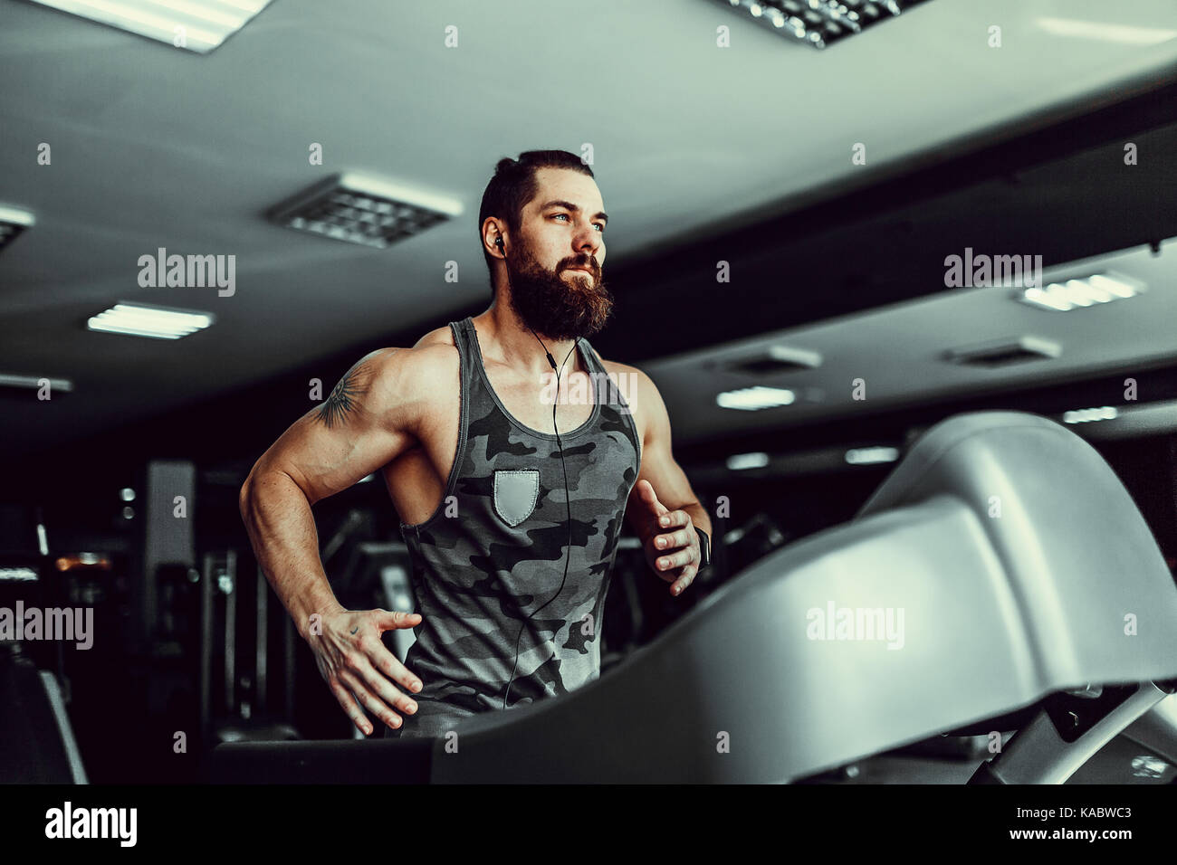 Muscle man running on treadmill Stock Photo - Alamy