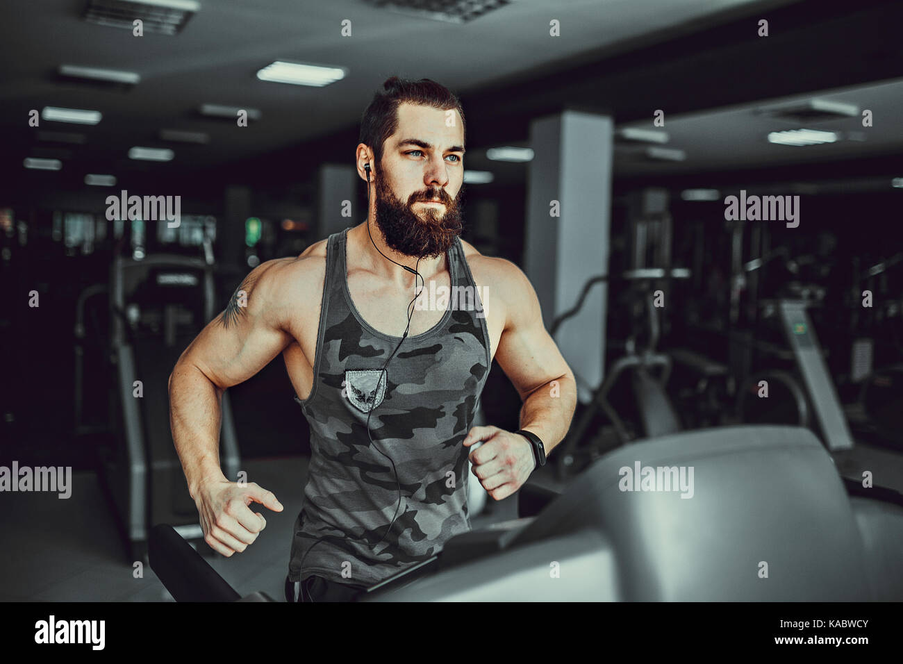 Muscle man running on treadmill Stock Photo - Alamy