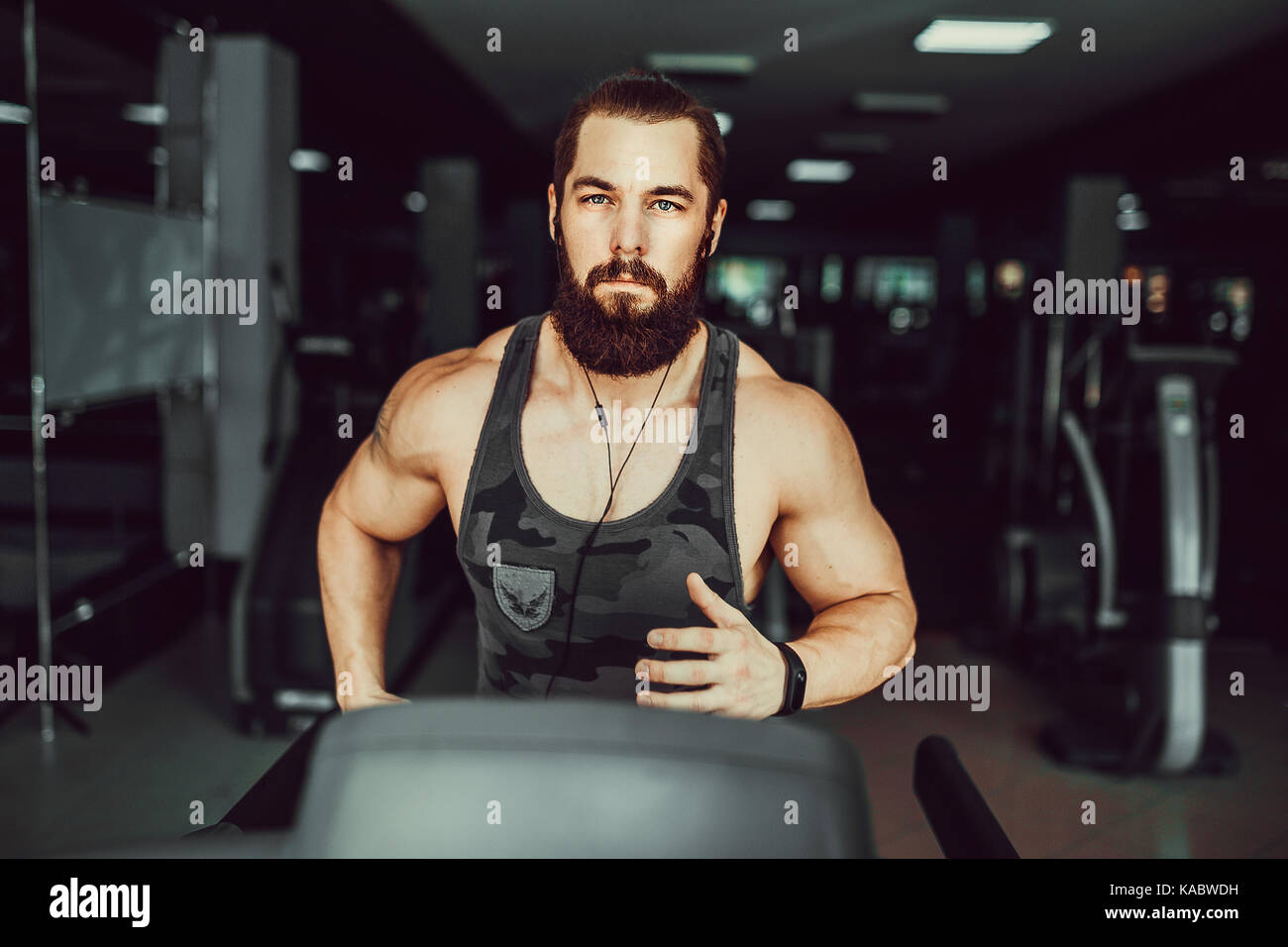 Muscle man running on treadmill Stock Photo - Alamy