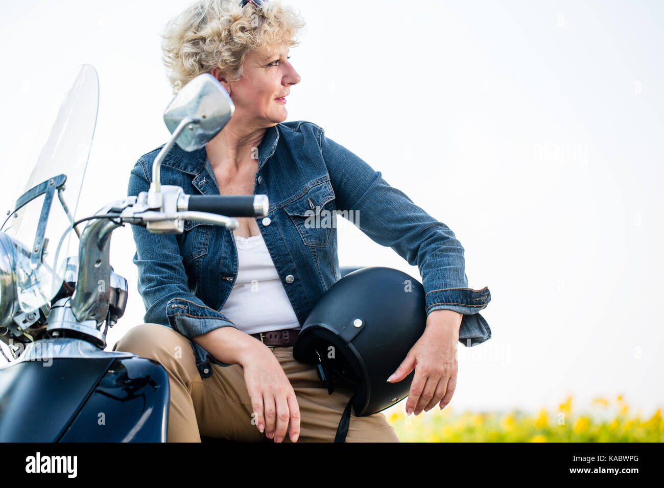 Senior woman sitting motorcycle hi-res stock photography and images - Alamy